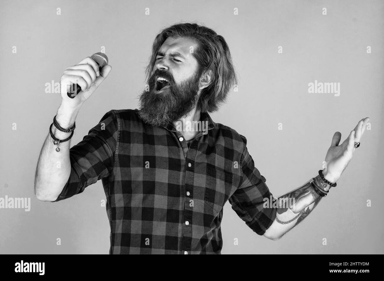 express yourself. bearded man wear checkered shirt singing song. male ...