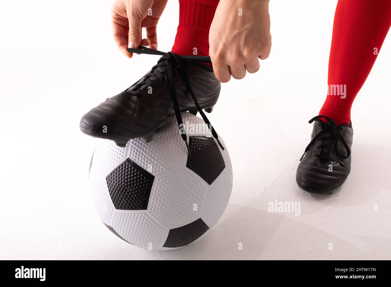 Close-up of caucasian young female player tying shoe lace while ...