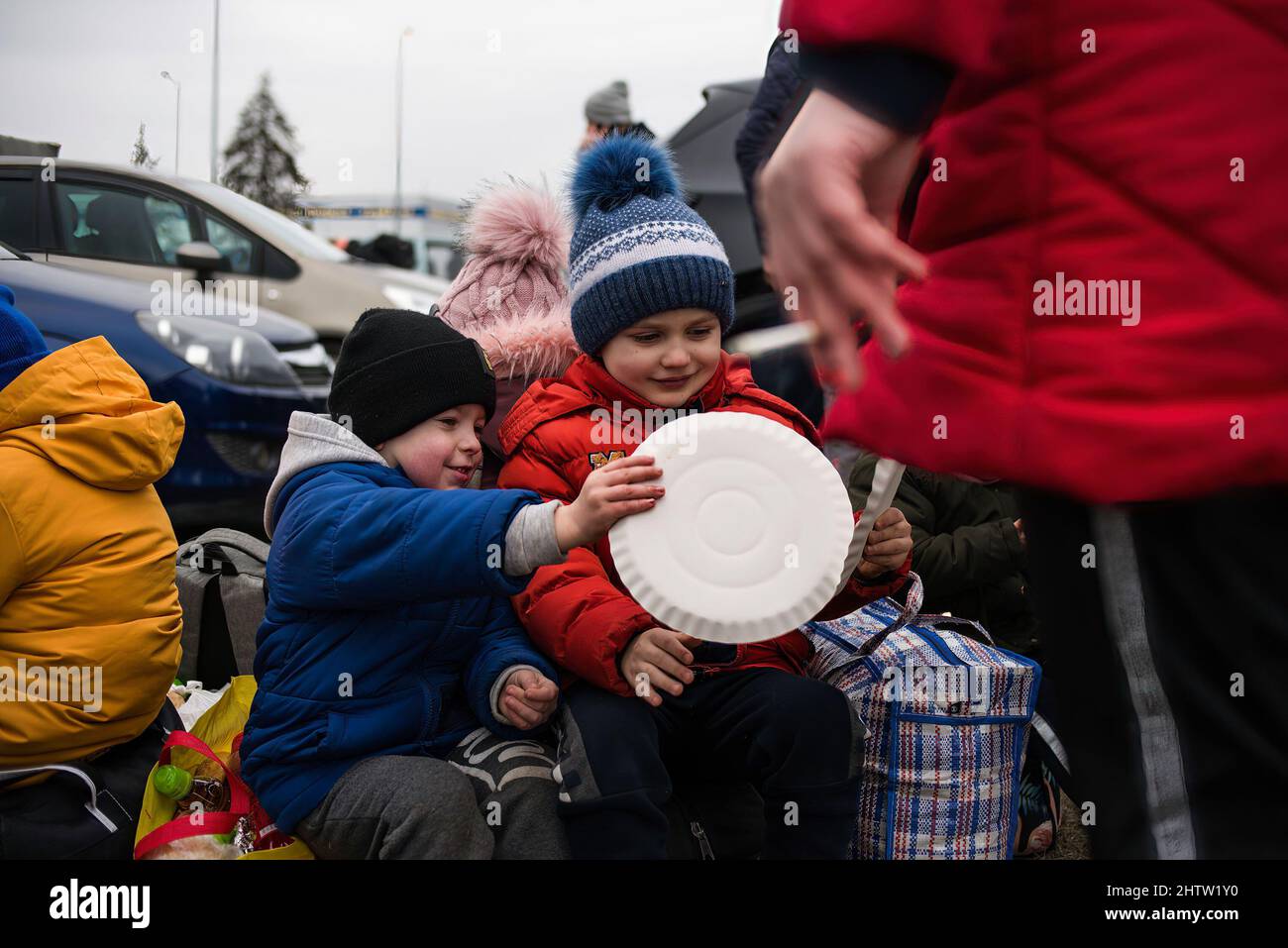 Ukrainian children are seen playing at the temporary refugee bus stop ...