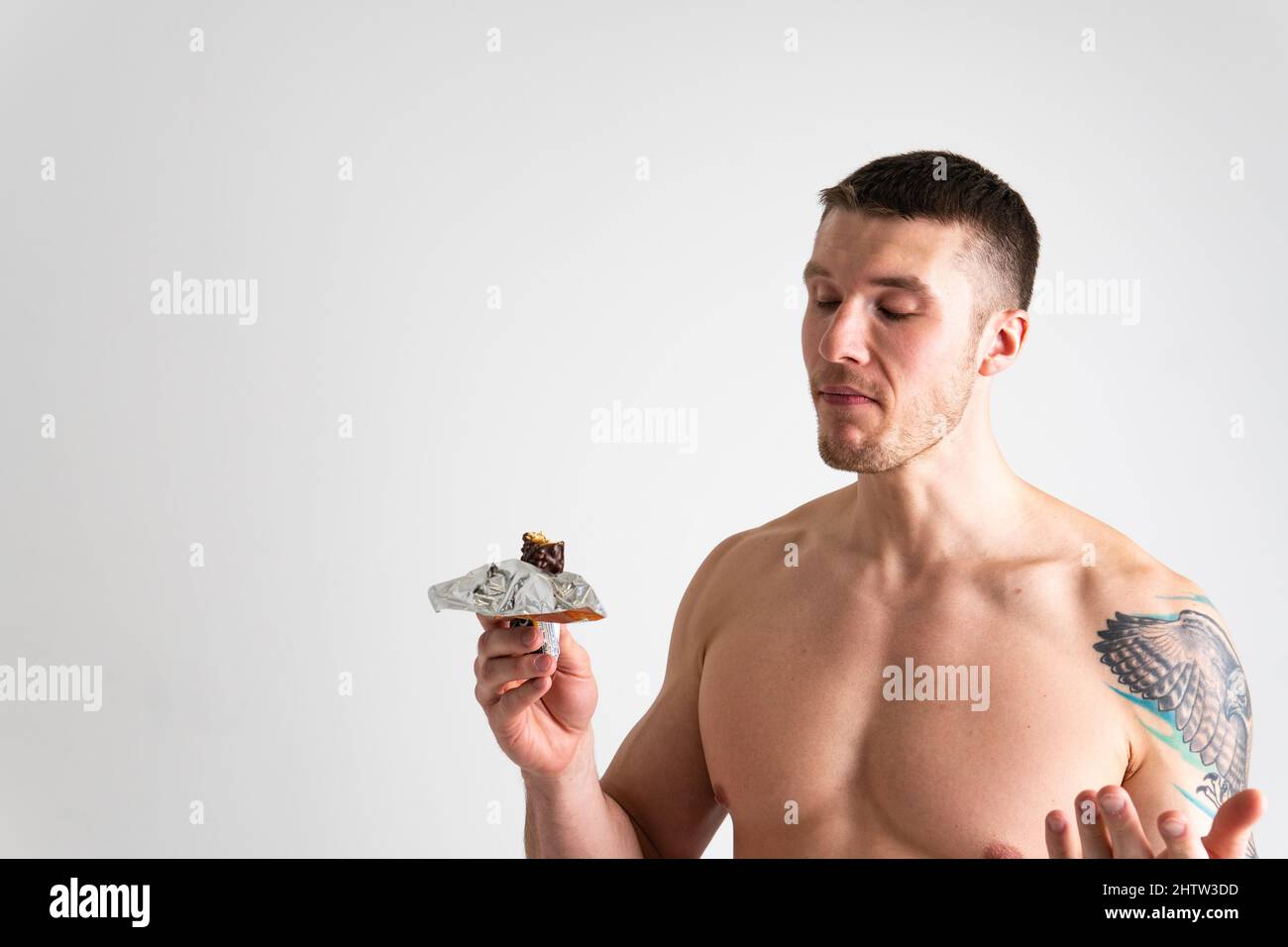 Man eats protein bar on white background isolated bar snack healthy ...