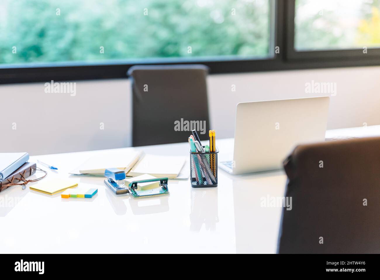 Home office work table with laptop and others Stock Photo - Alamy