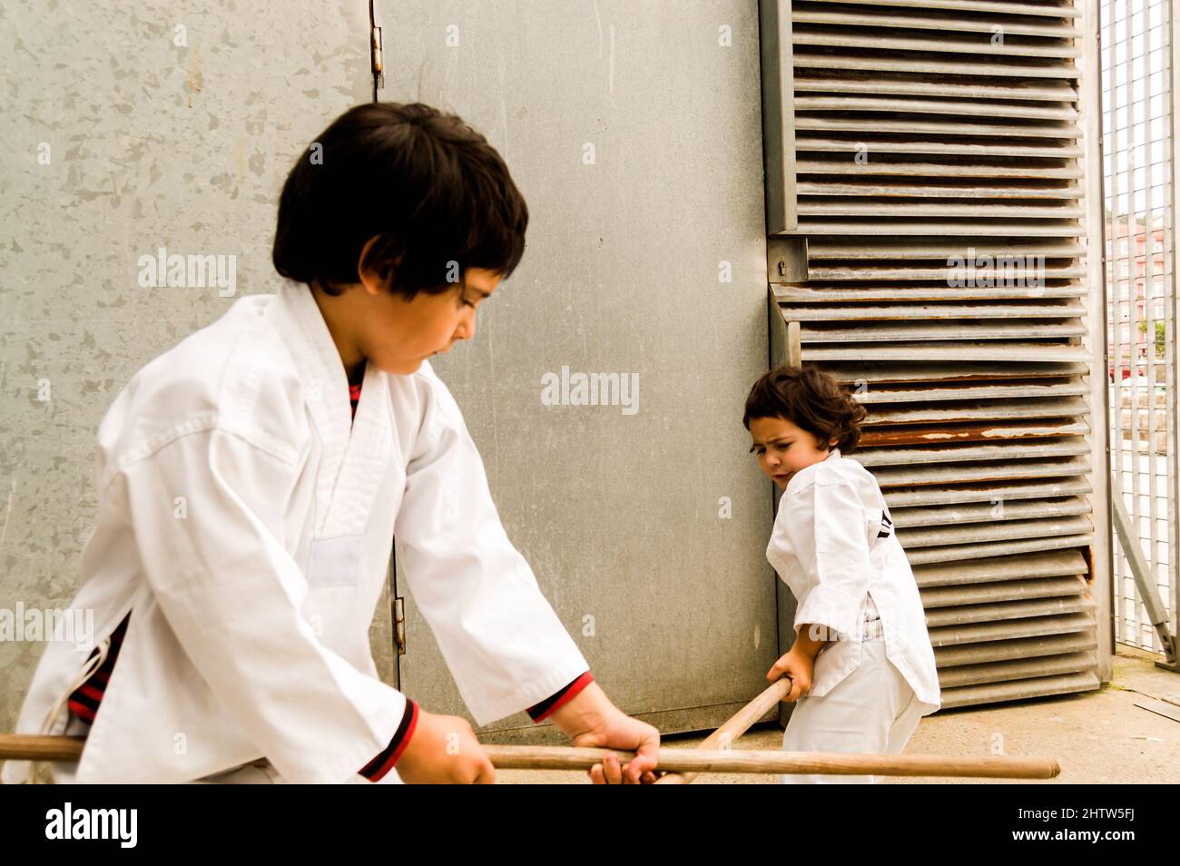 two children play karate in the street Stock Photo - Alamy