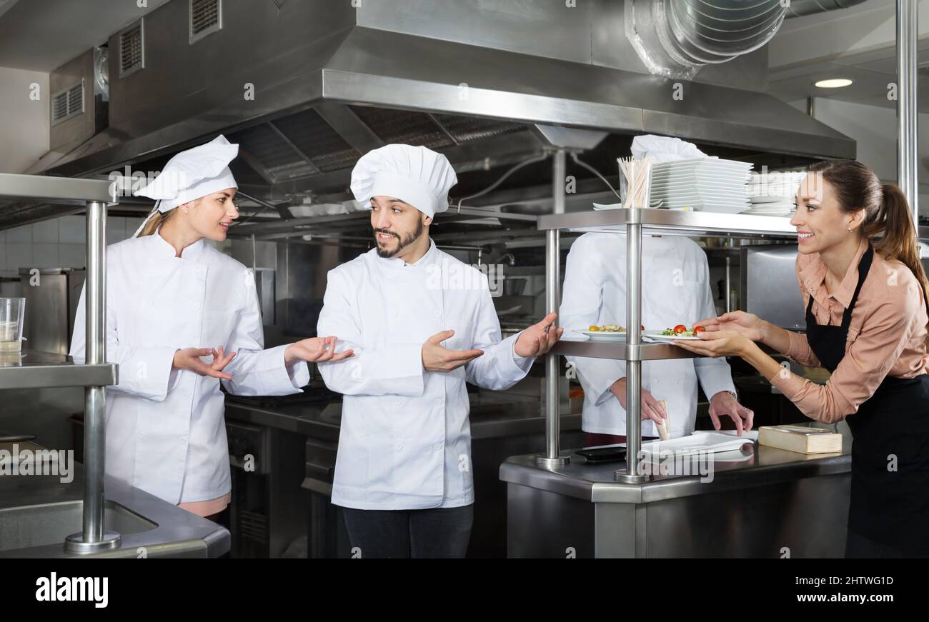 Chef checking dishes in kitchen of restaurant Stock Photo - Alamy
