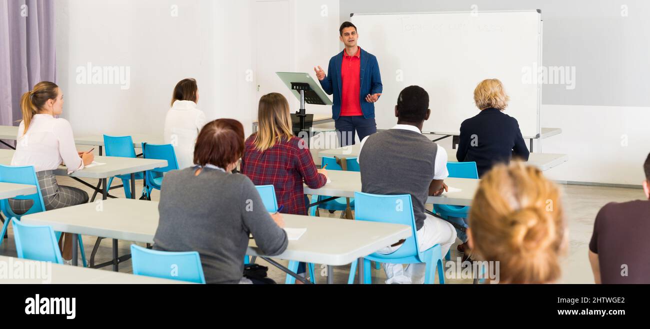 Male teacher lecturing to students Stock Photo - Alamy