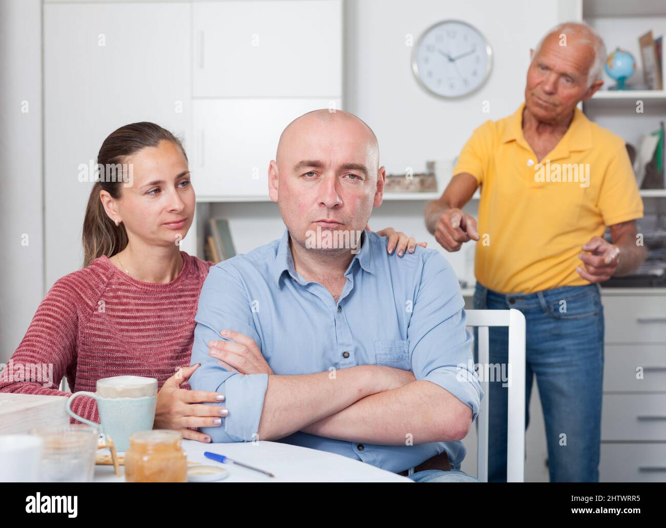 Wife calms husband after his quarrel with father Stock Photo - Alamy