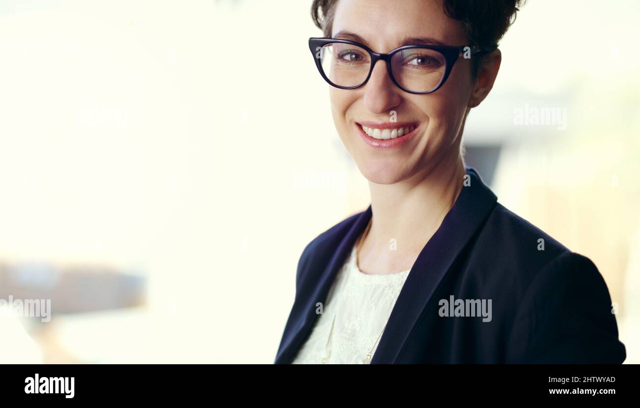 Success is its own reward. Cropped portrait of an attractive young businesswoman standing ...