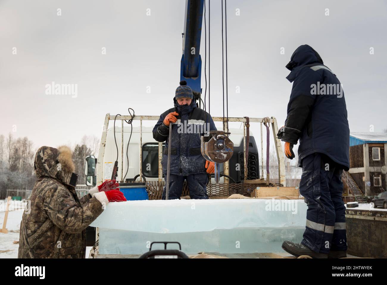 Installers adjust and install another ice block to the overall ... Installers adjust and install another ice block to the overall ...