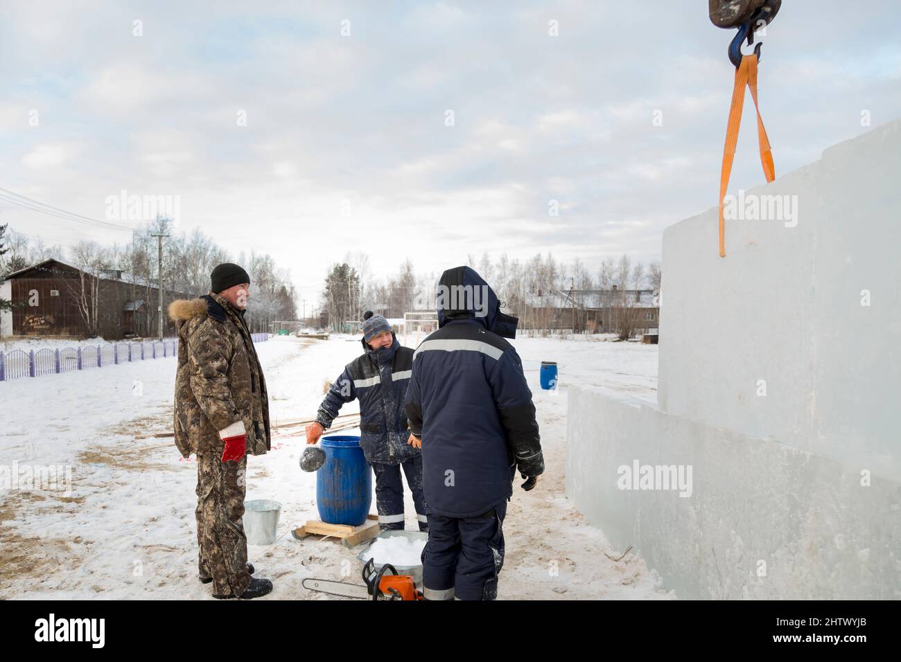 Installers adjust and install another ice block to the overall ...