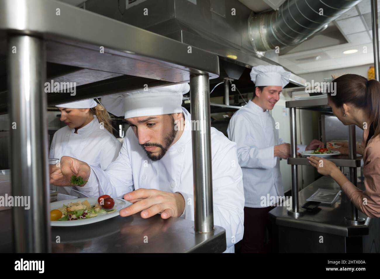 Chef with team preparing food Stock Photo - Alamy
