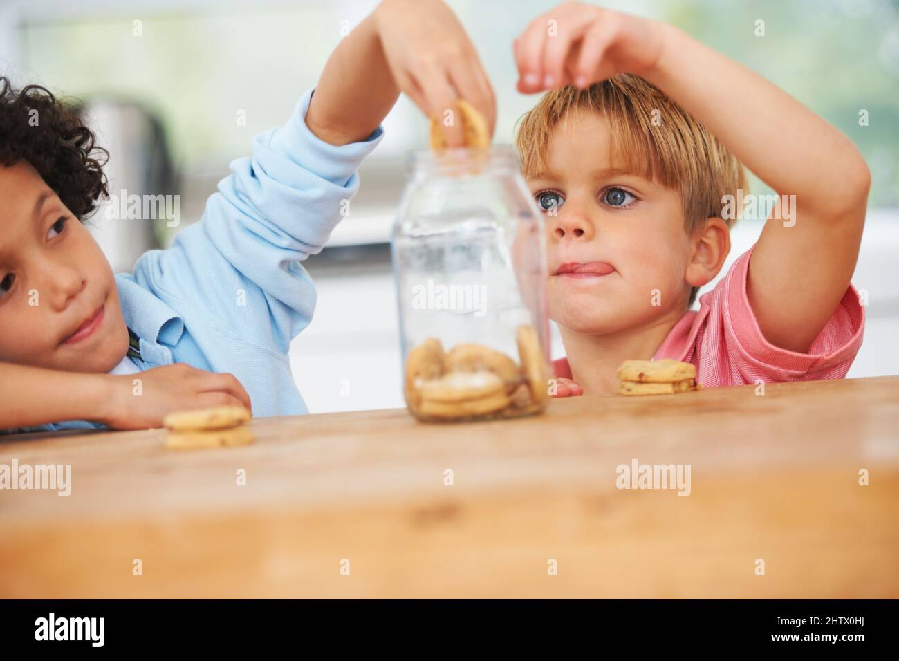 Cookies are the best. A little boy grabbing some cookies Stock Photo ...