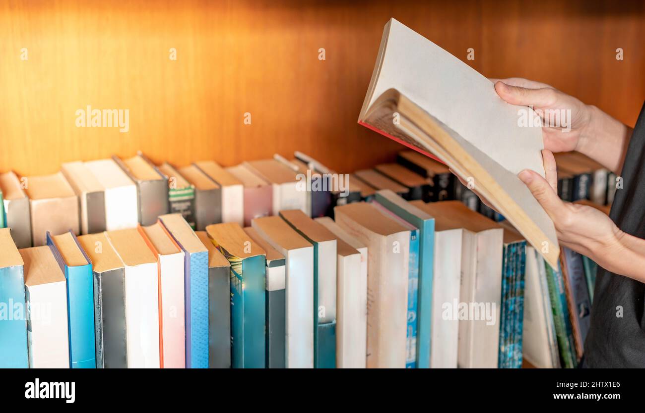 Female hand holding notebook and reading book for relaxing and the ...