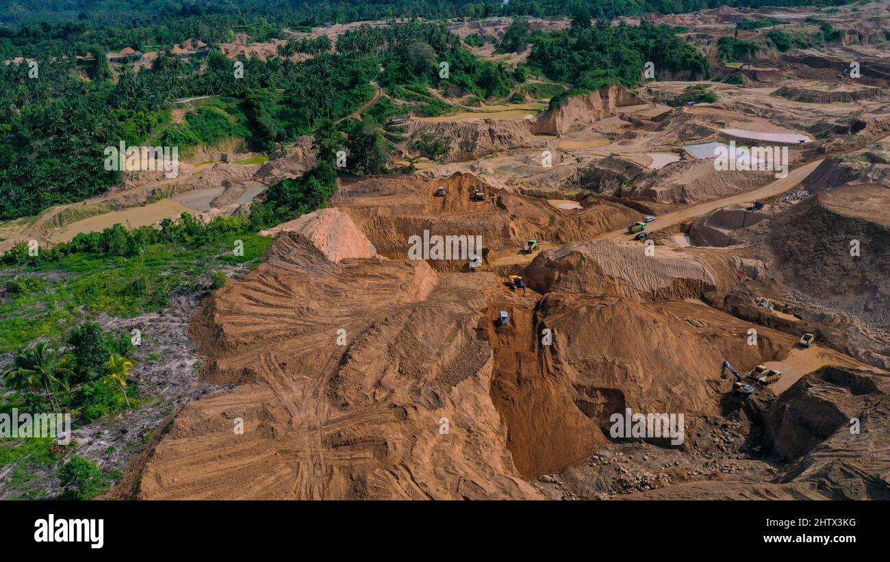 Aerial view of Work of trucks and the excavator in an open pit on gold ...