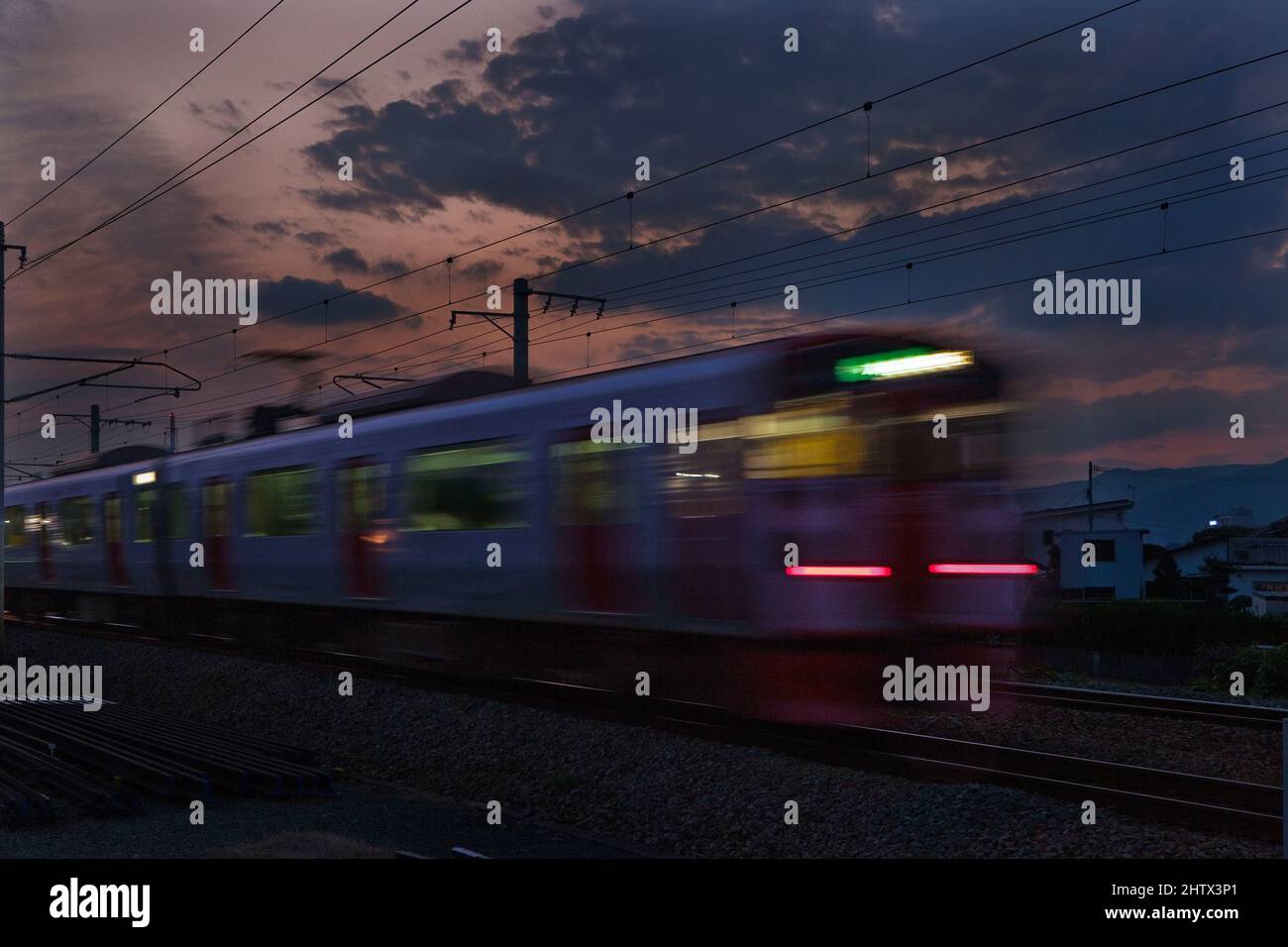 Blur of regional train at dusk in Tosu, Saga, Japan Stock Photo - Alamy