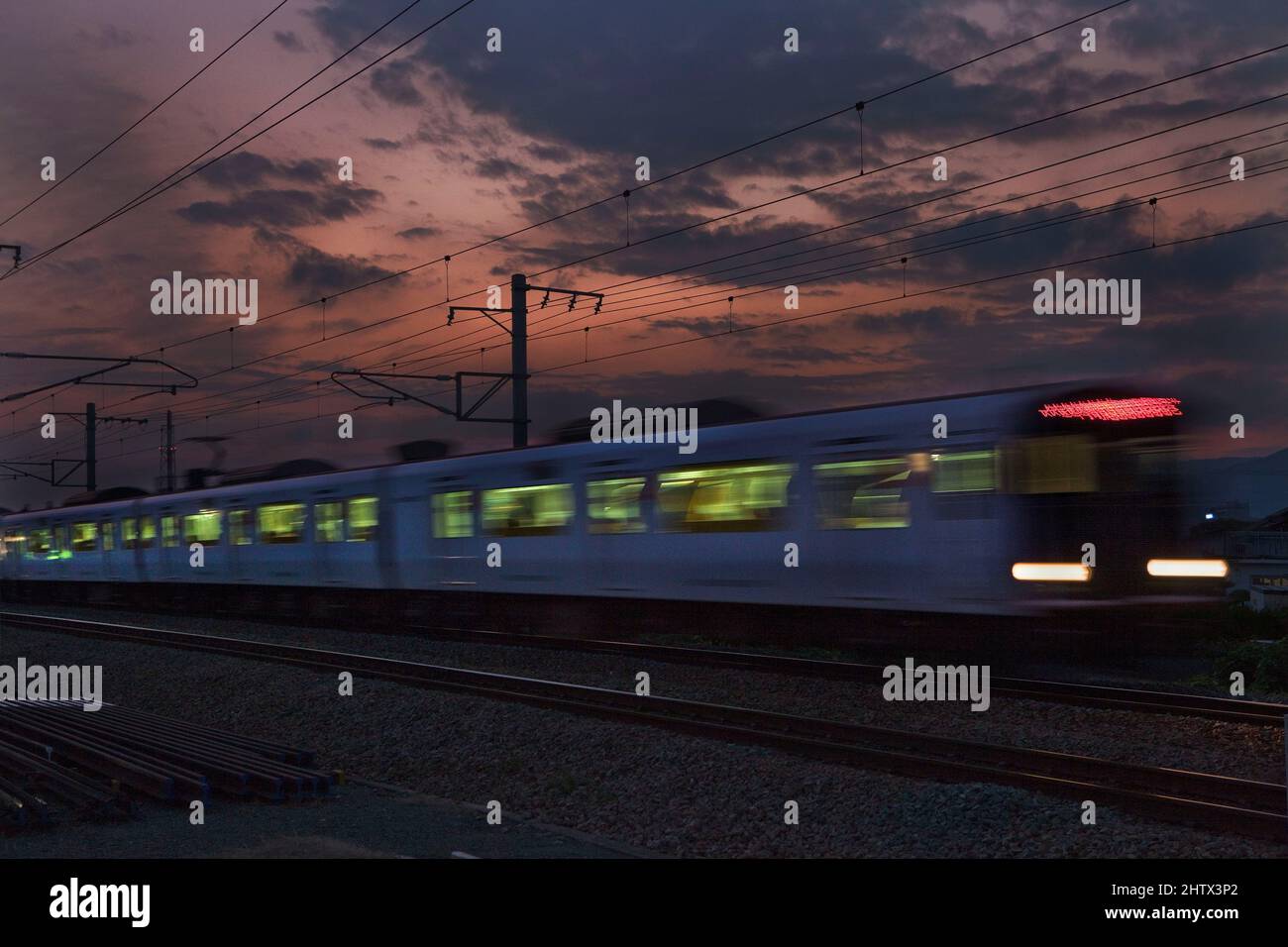 Blur of regional train at dusk in Tosu, Saga, Japan Stock Photo - Alamy