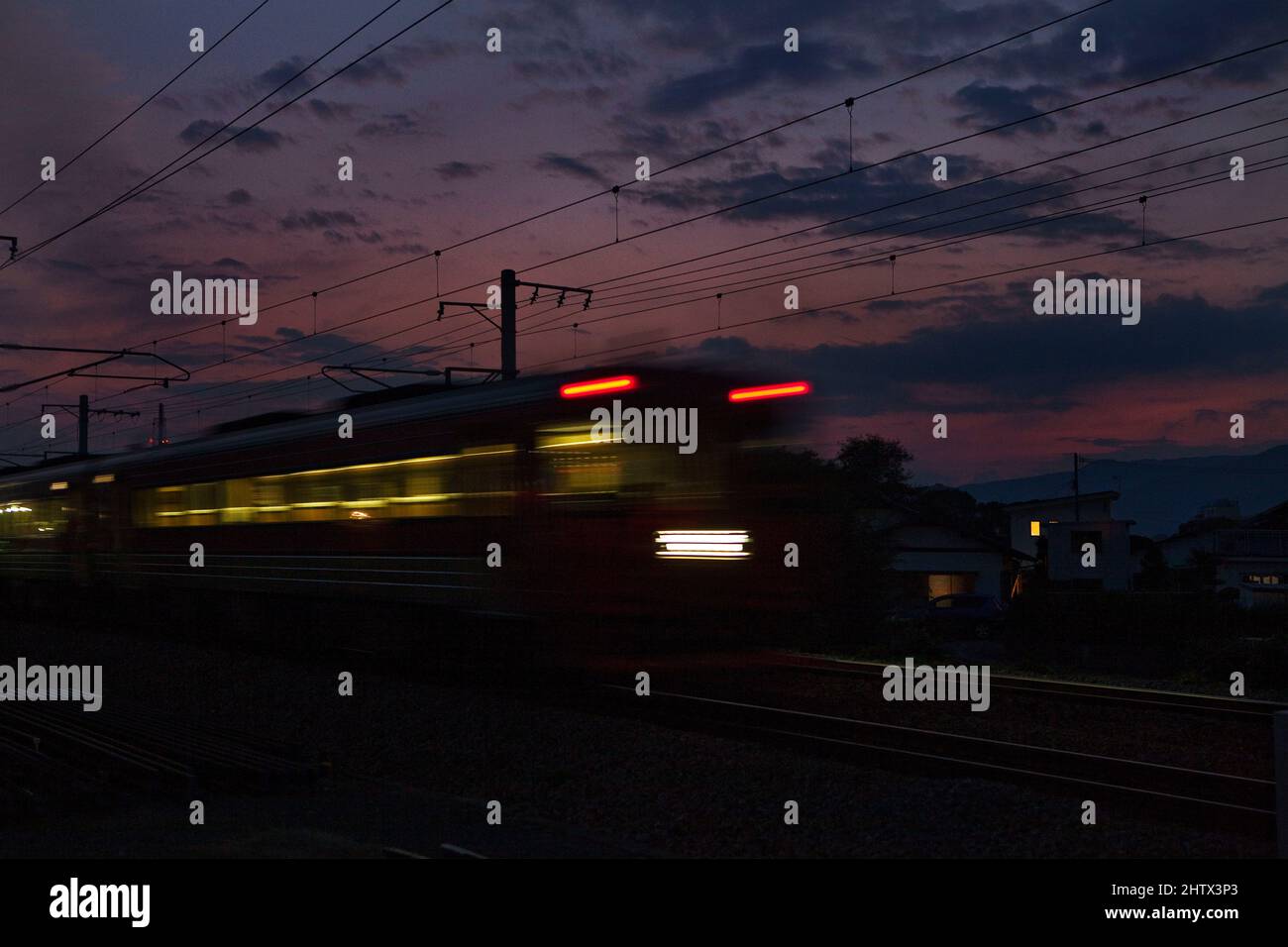 Blur of regional train at dusk in Tosu, Saga, Japan Stock Photo - Alamy