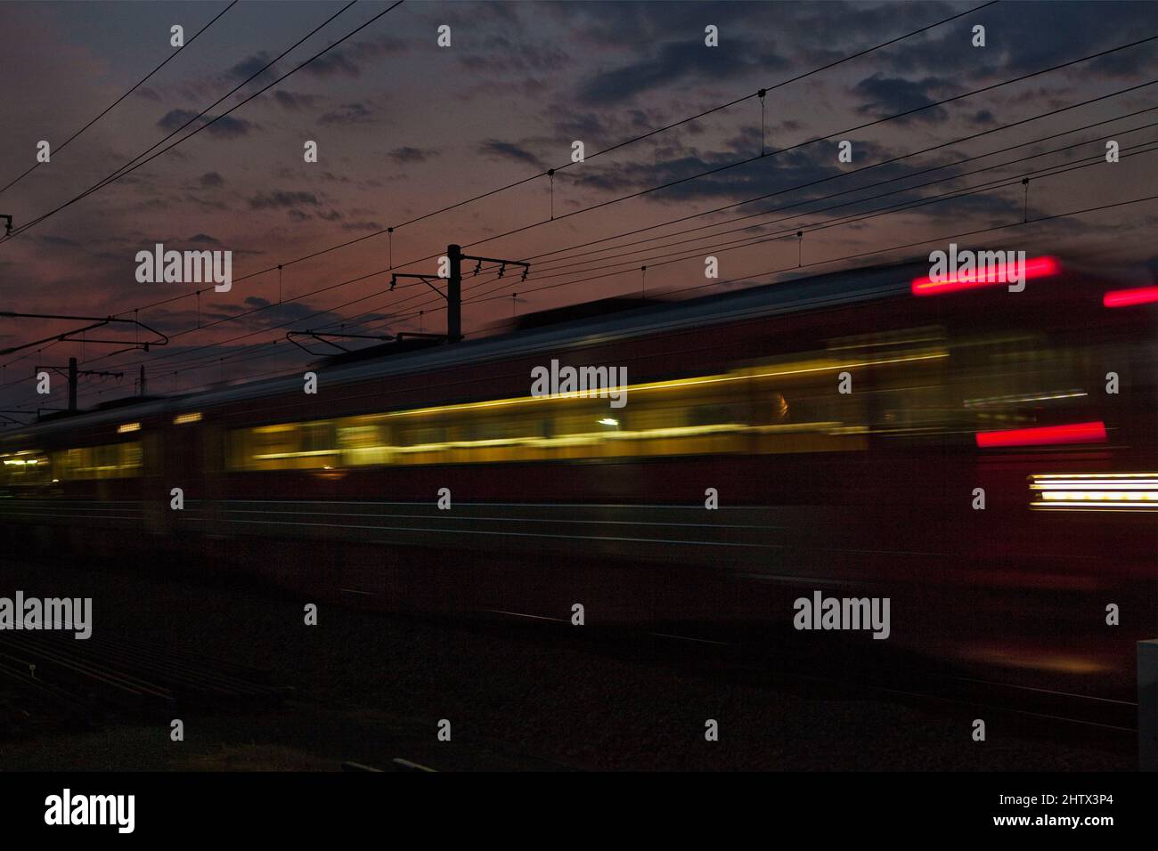 Blur of regional train at dusk in Tosu, Saga, Japan Stock Photo - Alamy