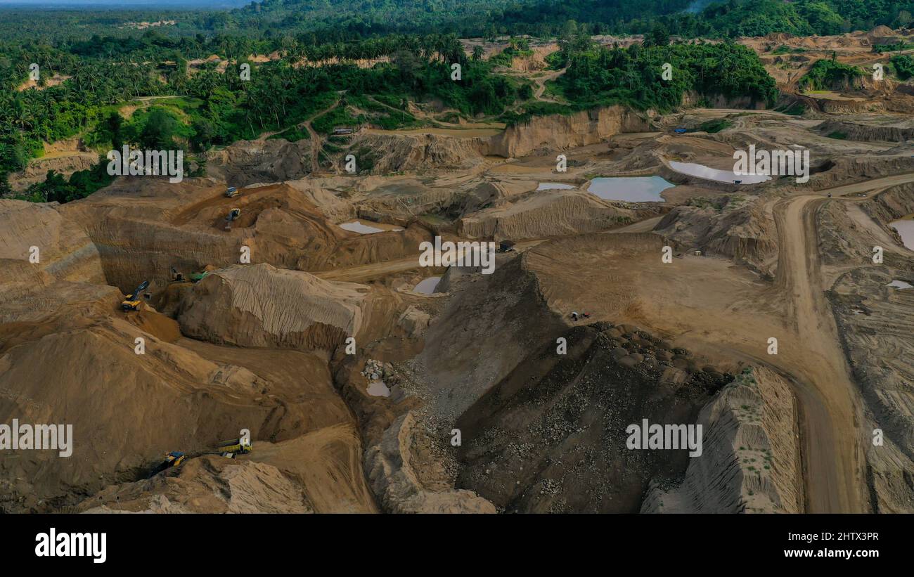 Aerial view of Work of trucks and the excavator in an open pit on gold ...