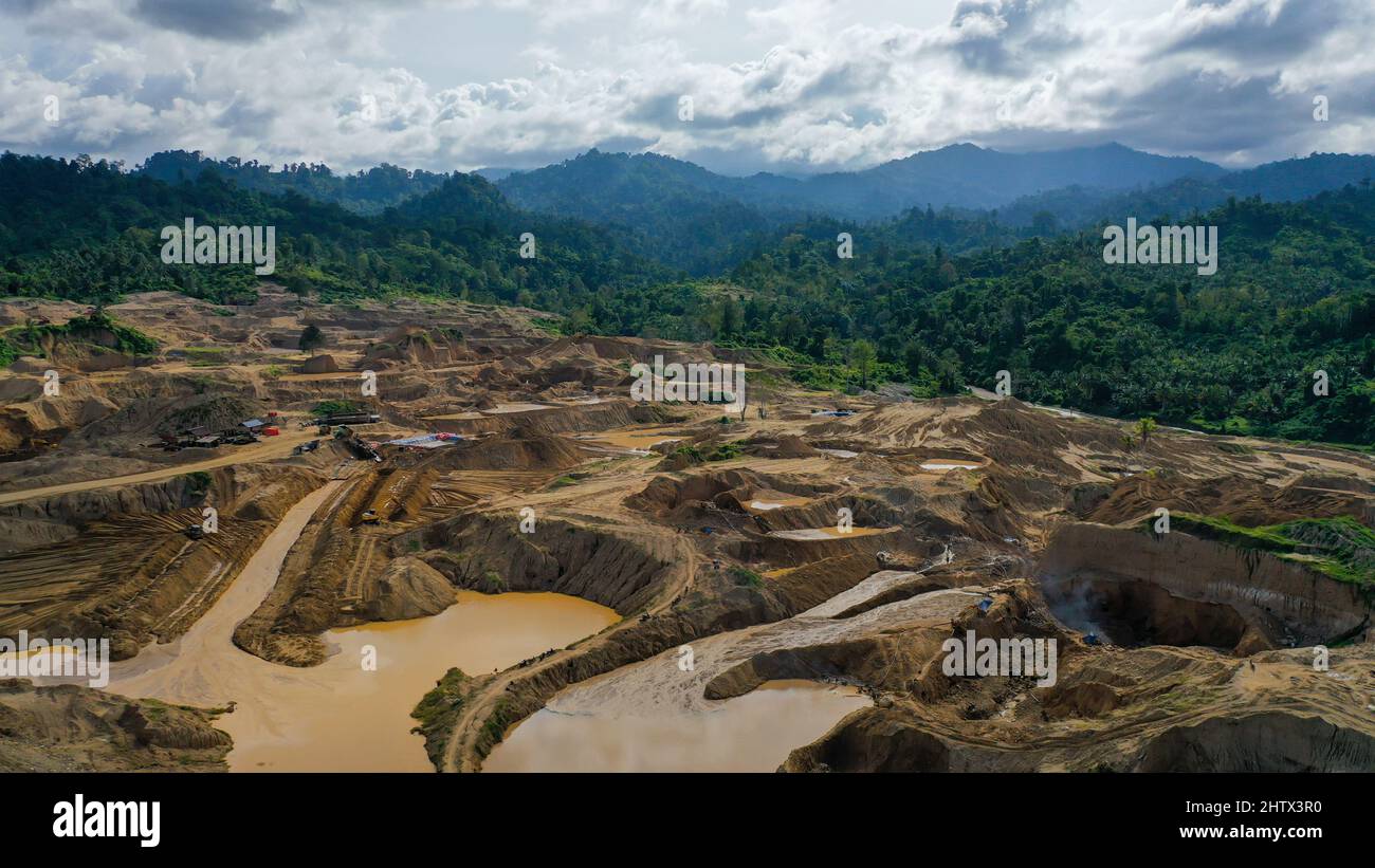 Aerial view of Work of trucks and the excavator in an open pit on gold ...