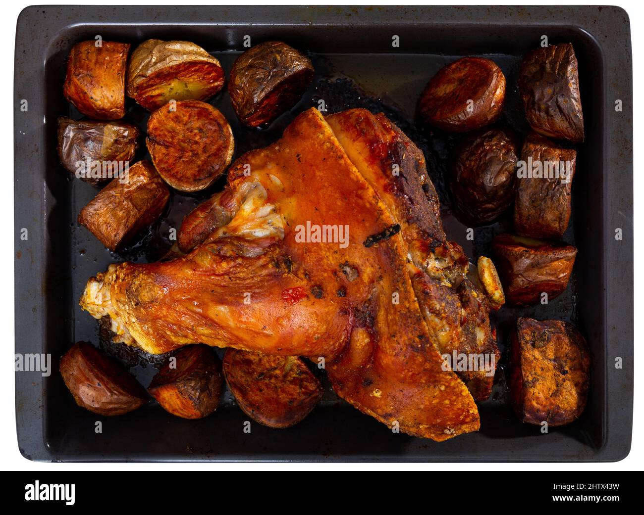 Roasted whole pork leg served in baking dish with potatoes Stock Photo ...