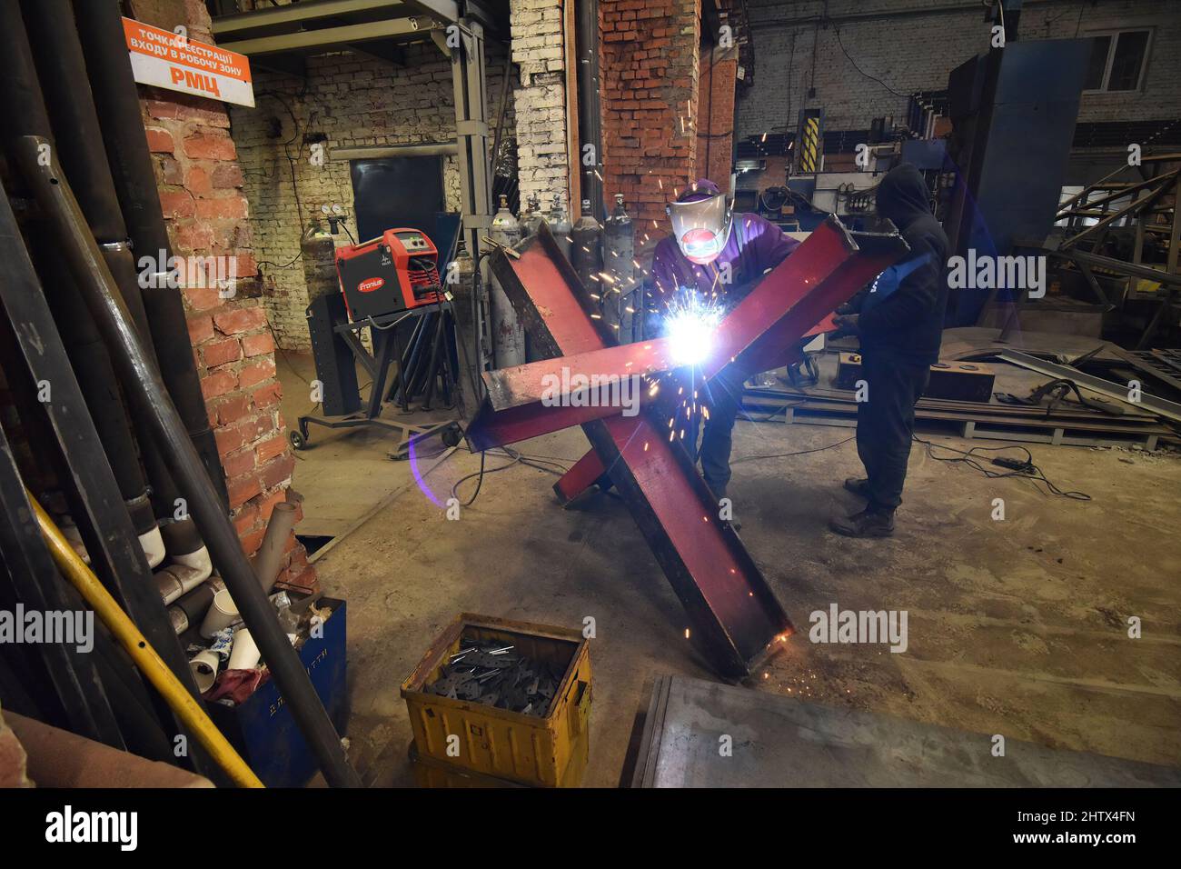 A Ukrainian volunteer seen producing anti-tank hedgehogs in Lviv. The ...