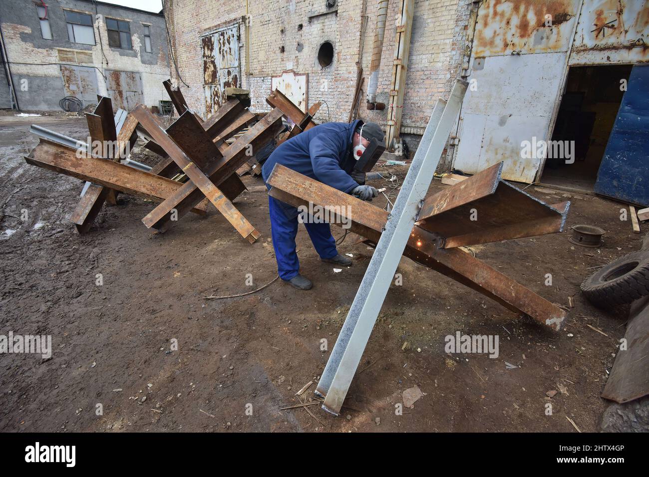 A Ukrainian volunteer seen producing anti-tank hedgehogs in Lviv. The ...