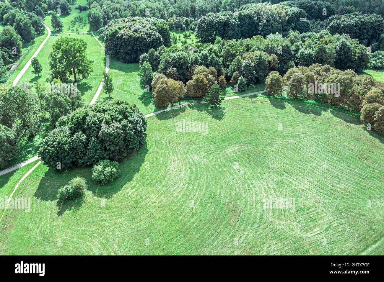 summer park landscape with green trees, lawn and walking paths. aerial ...