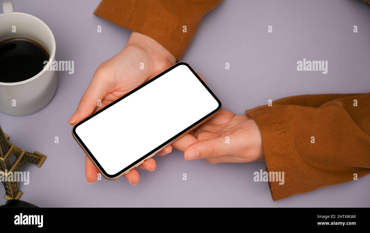 Close-up image, A girl using her modern smartphone over her pastel ...