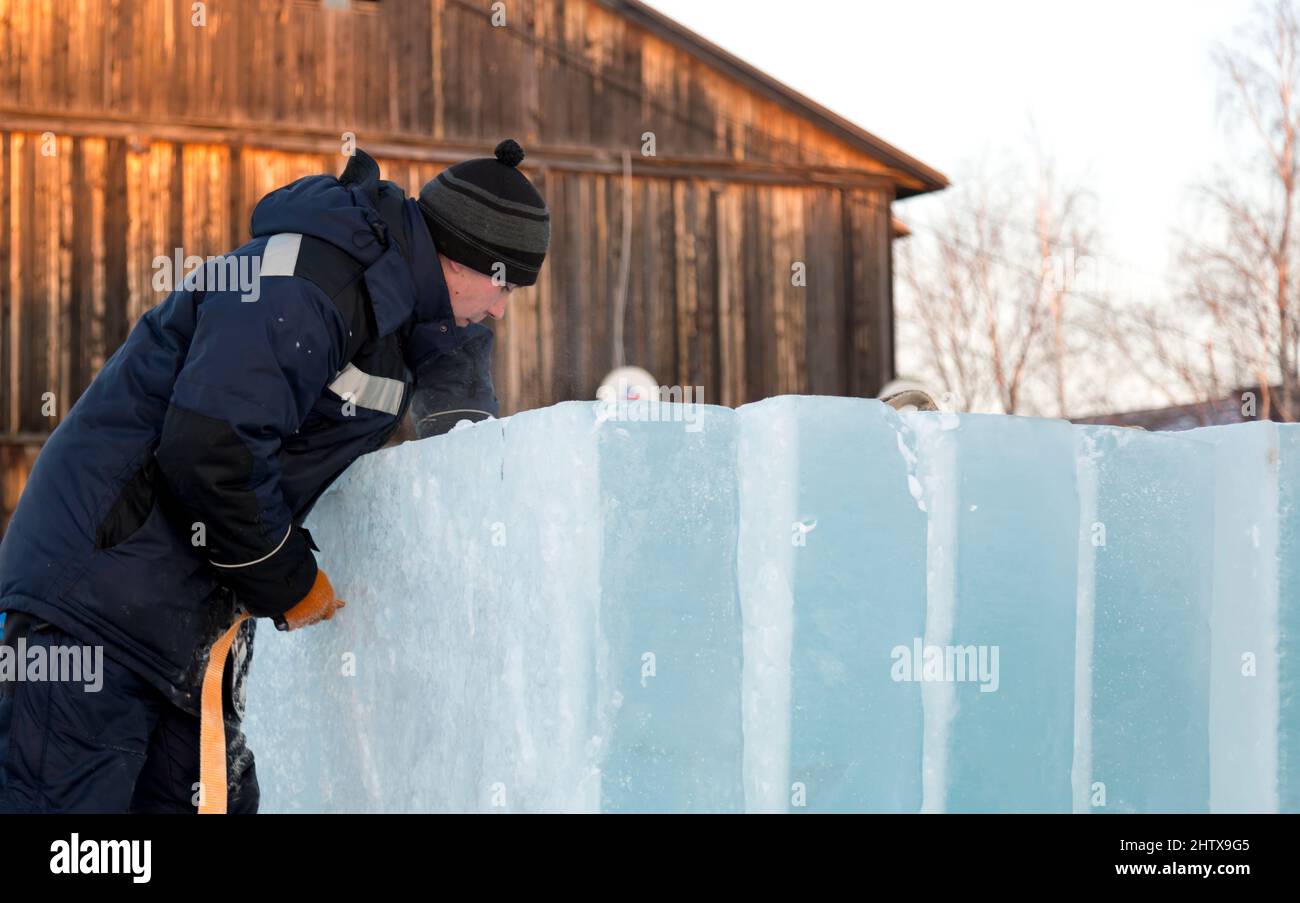 Installer in winter gear at the installation of ice panels Stock Photo ...