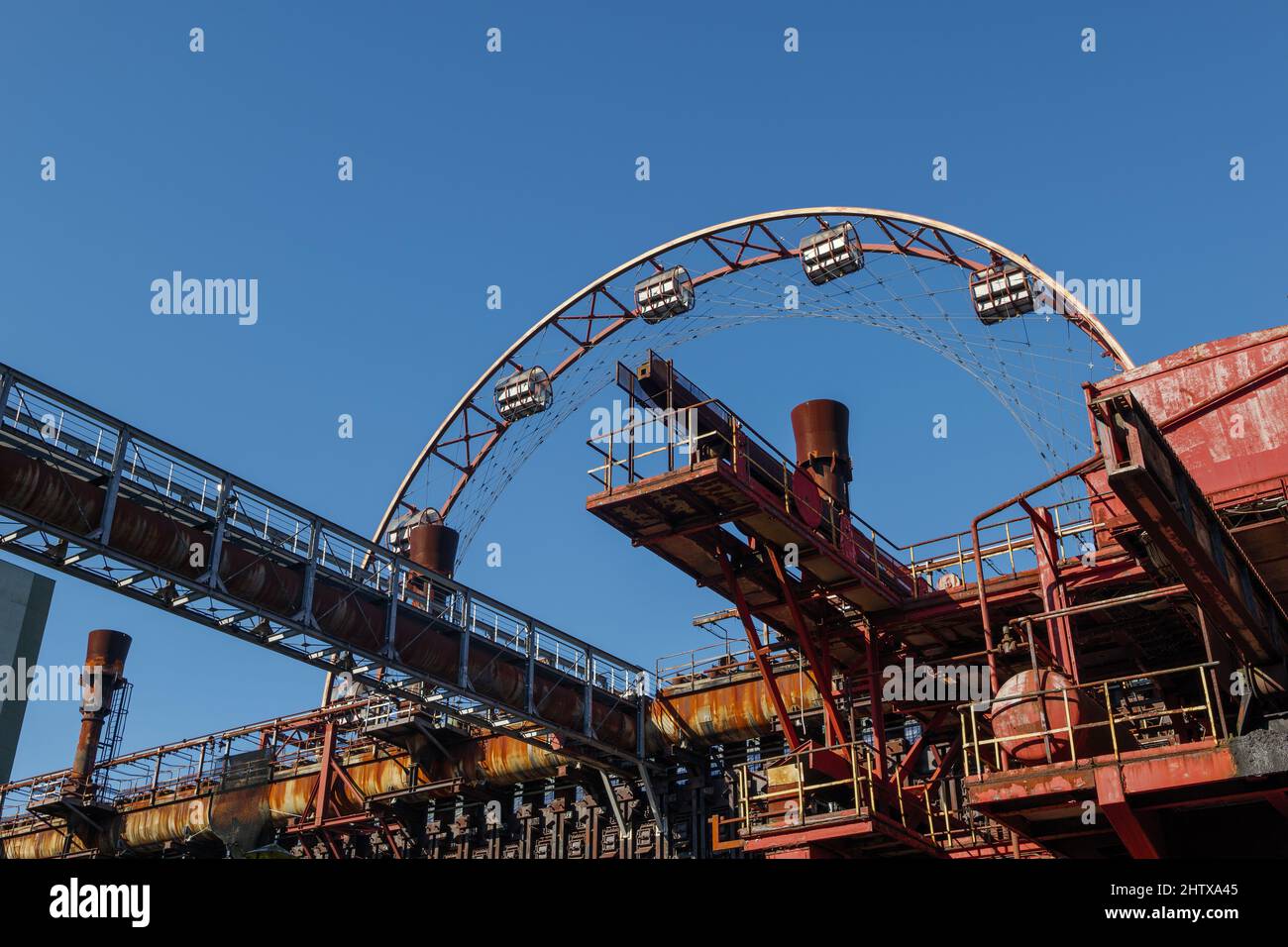 Old rusty machine with complex vault, pipeline and utilities in former ...