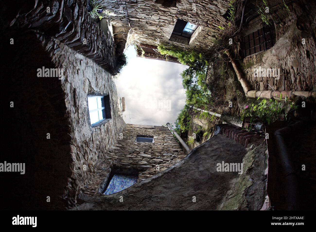 Low angle of narrow space in the middle of a old walled buildings Stock ...