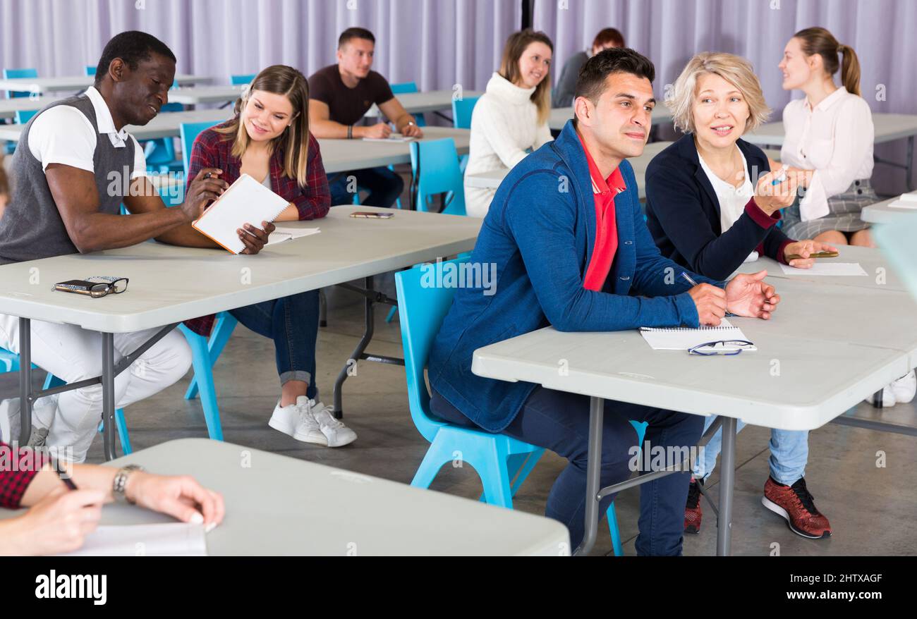 Adult students discussing lesson Stock Photo - Alamy