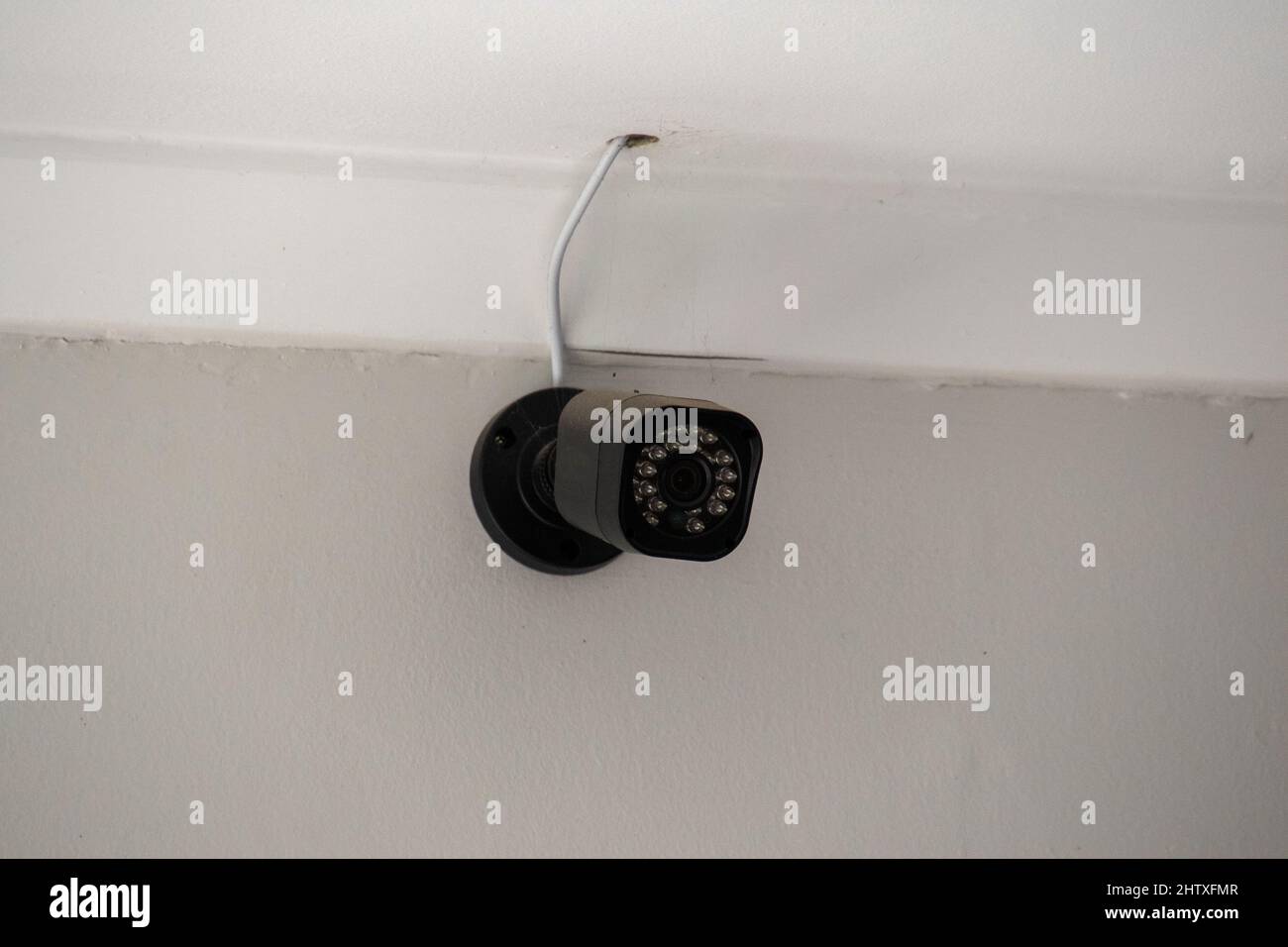 Indoor security camera mounted below the ceiling Stock Photo - Alamy