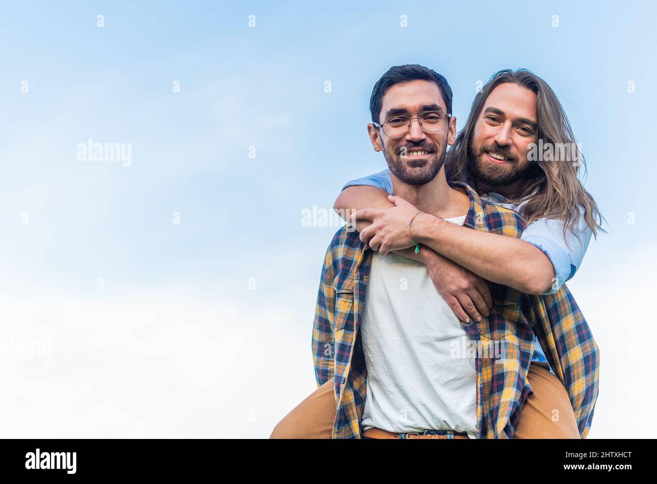 A young man carrying his partner on his back Stock Photo - Alamy