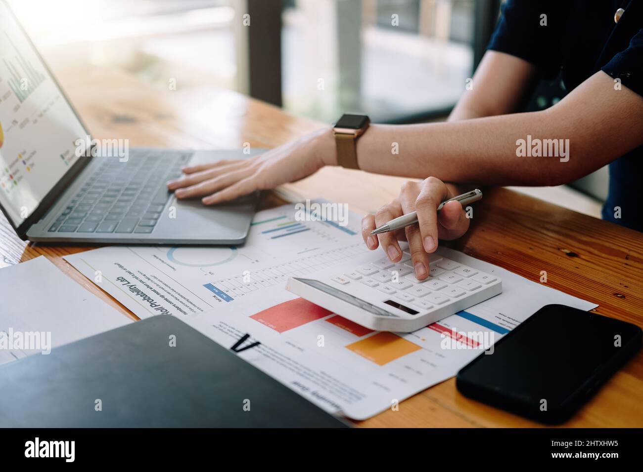 businesswoman accountant working using a calculator and laptop computer ...