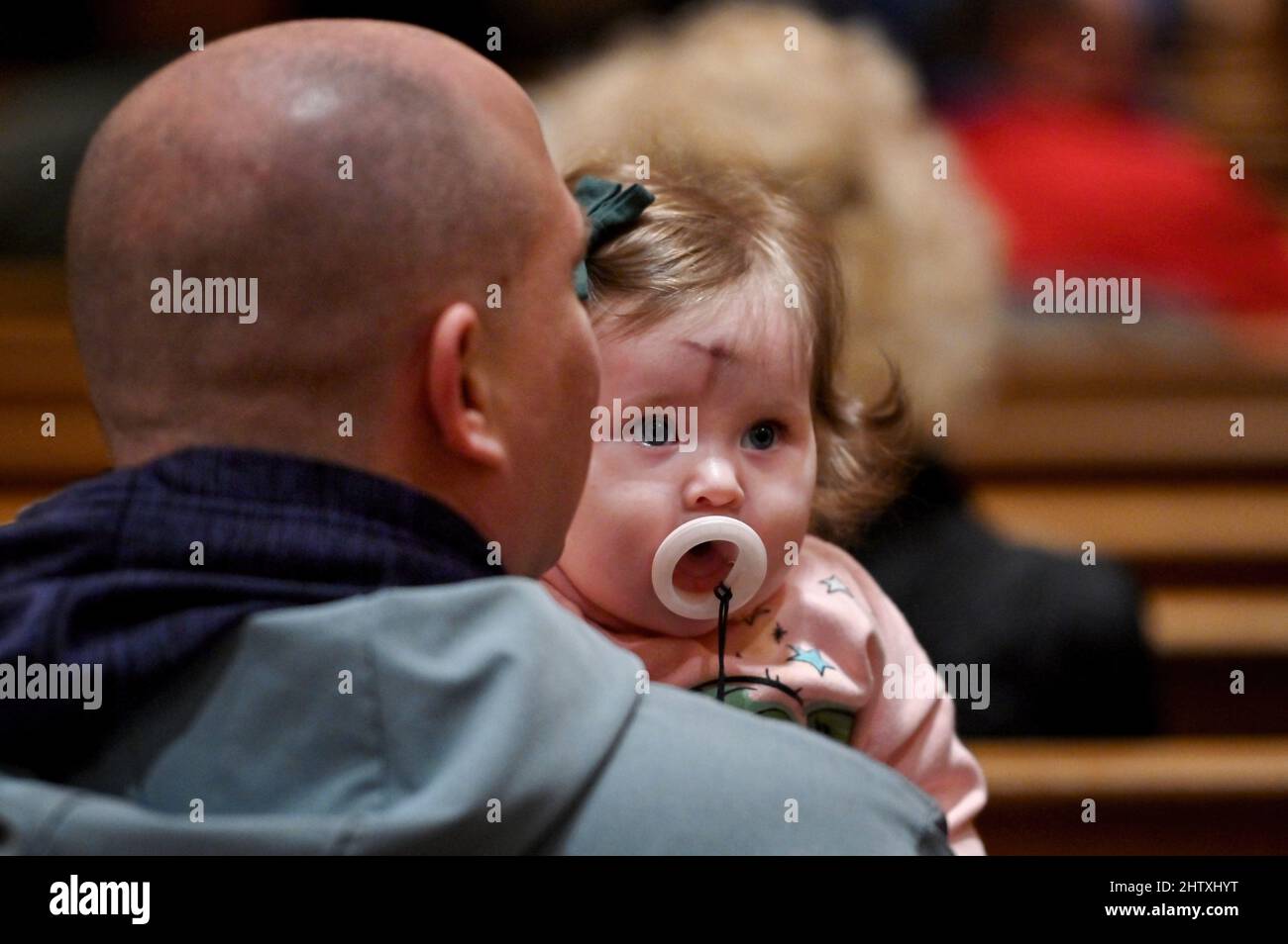 A kid seen after receiving ash at Saints Peter and Paul Catholic Church ...