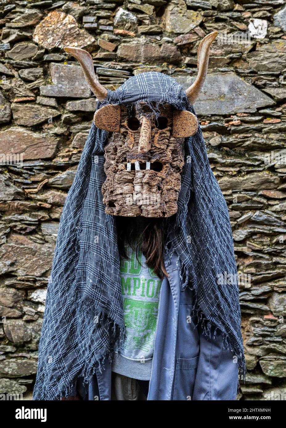 A reveler wearing a cork mask poses for a photo during the celebration ...