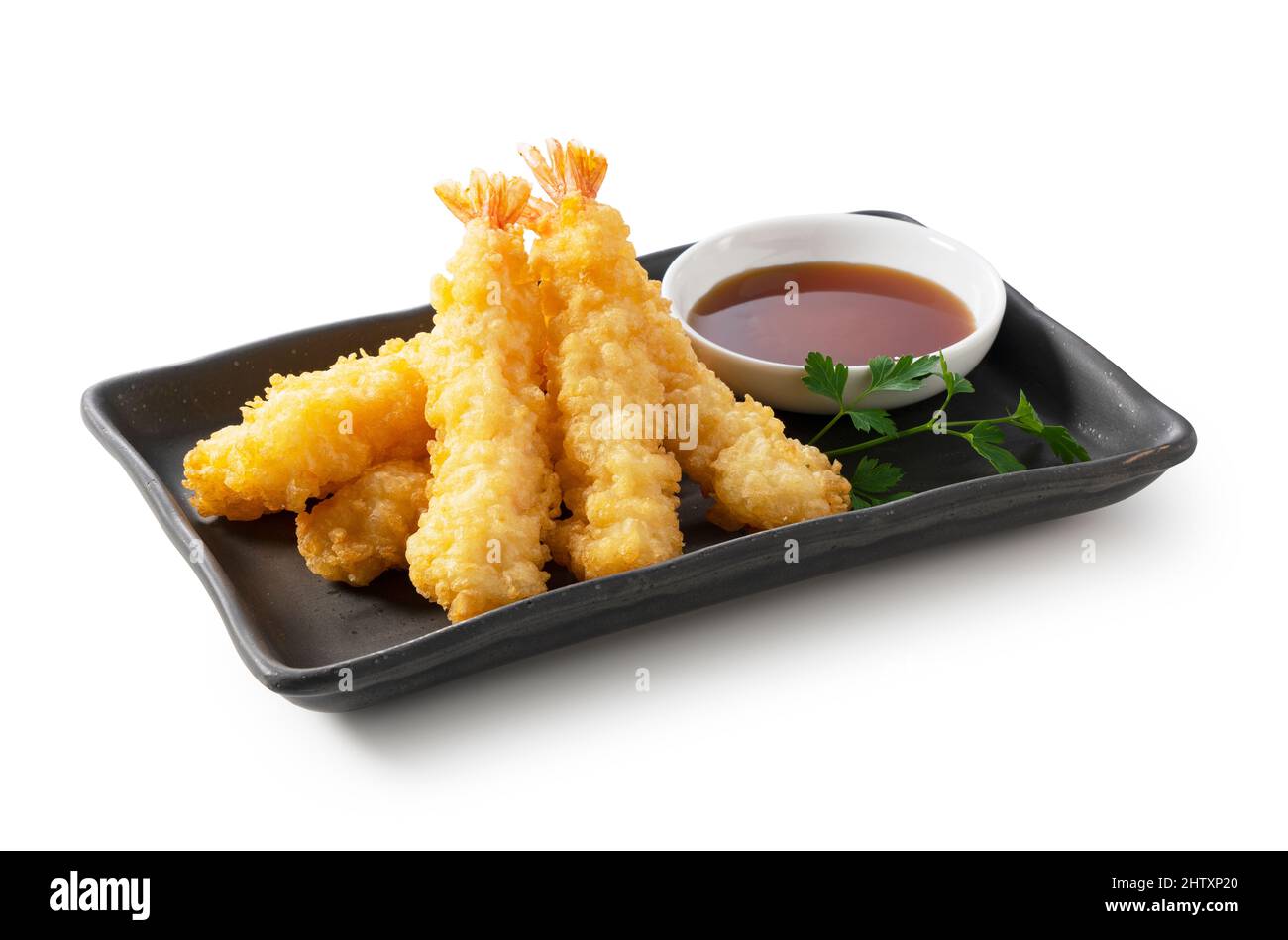 Shrimp tempura on a plate placed on a white background. Tempura is a ...