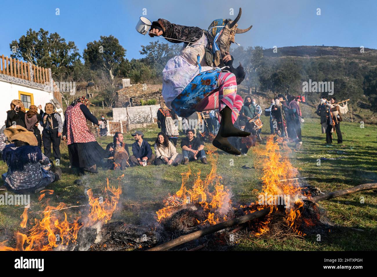 Gois, Portugal. 27th Feb, 2022. A reveler wearing a cork mask is seen ...