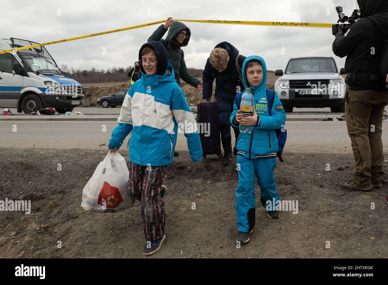 A family crosses the police line after crossing the Ukrainian Polish ...