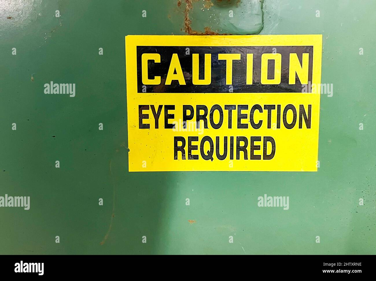 Caution eye protection yellow-colored sign with green background Stock ...