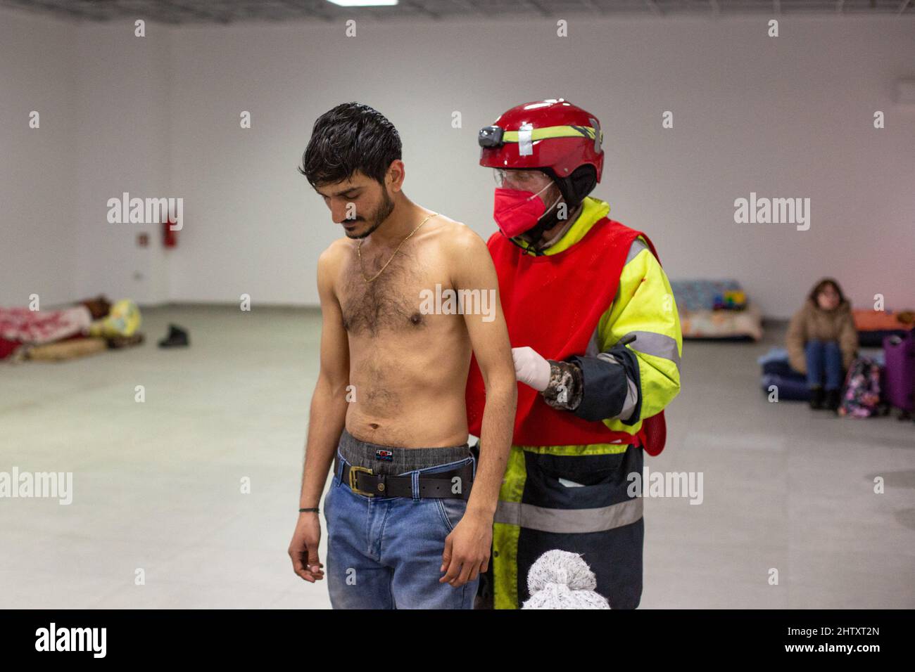 Vijay, a 29 years old Indian refugee is treated by an NGO volunteer in ...