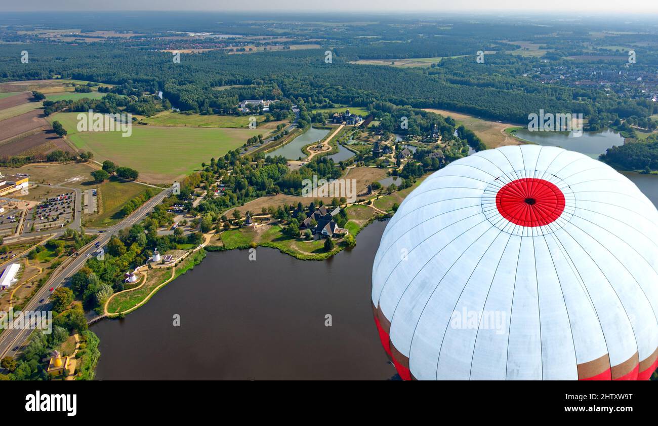 Aerial view over lake with mills and buildings on shore looking at top ...