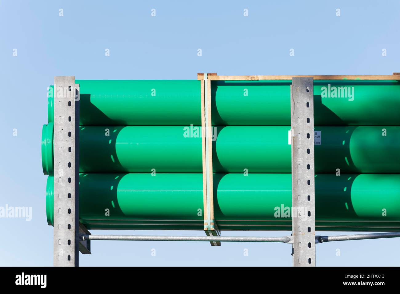 Green plastic sewage pipes in a warehouse for building material, civil ...
