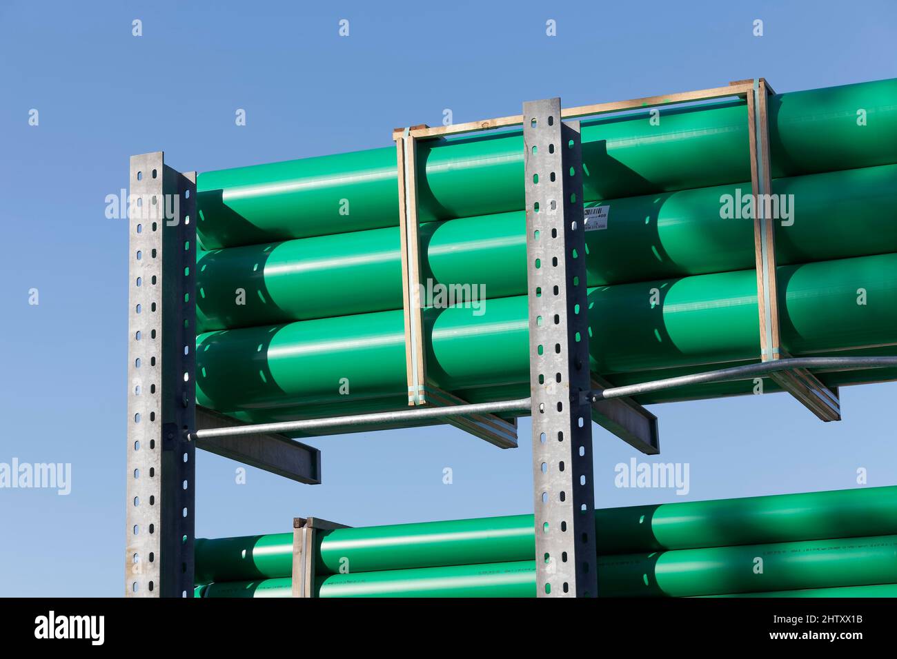 Green plastic sewage pipes in a warehouse for building material, civil ...