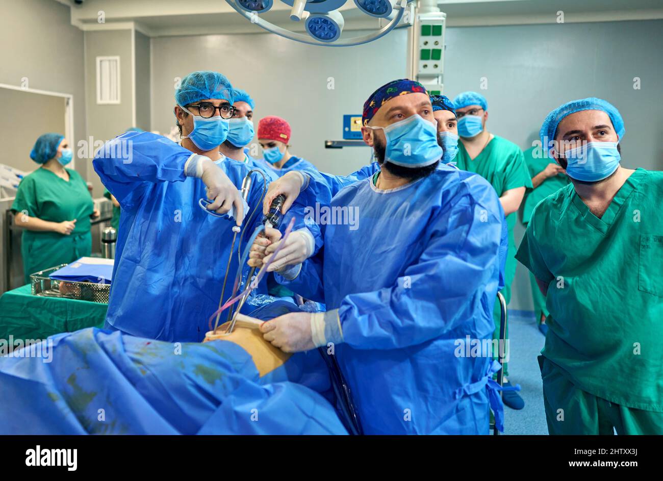 doctors in the operating room perform surgery on a patient Stock Photo ...