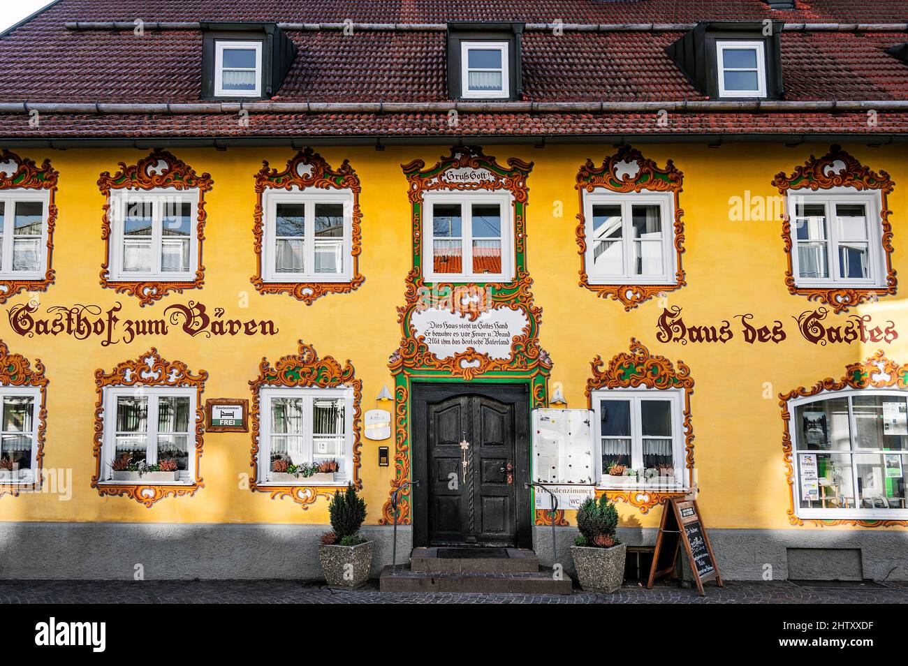 Yellow facade with paintings, Landgasthof zum Baeren, Altusried ...