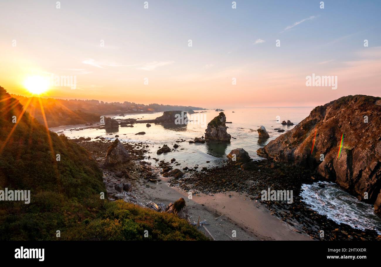 View of sea and sandy beach Harris Beach with rocks at sunrise with sun ...