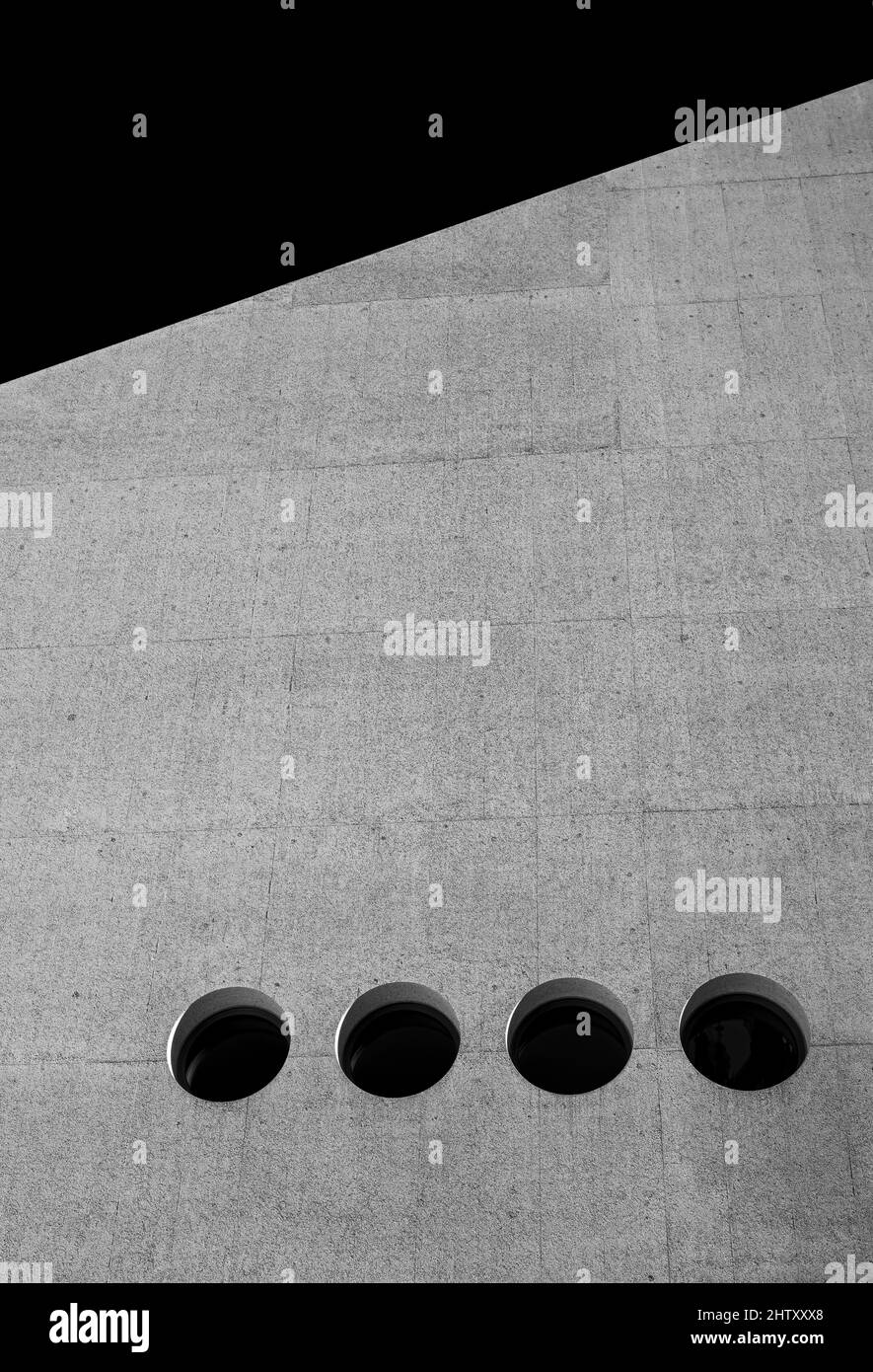 Black and white, concrete facade with round windows, Swiss National ...