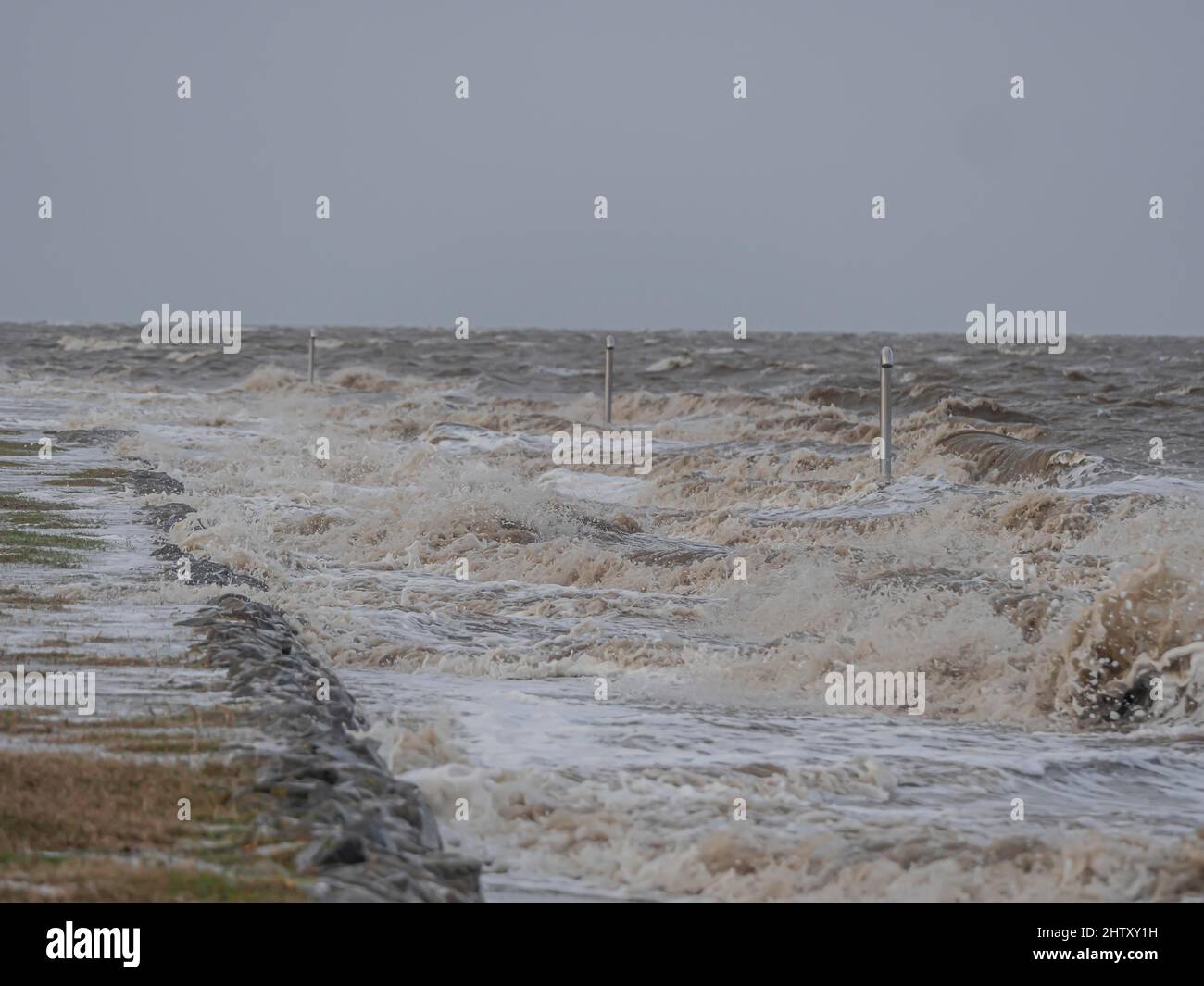 North Sea at storm surge, promenade is flooded, waves breaking, showers ...