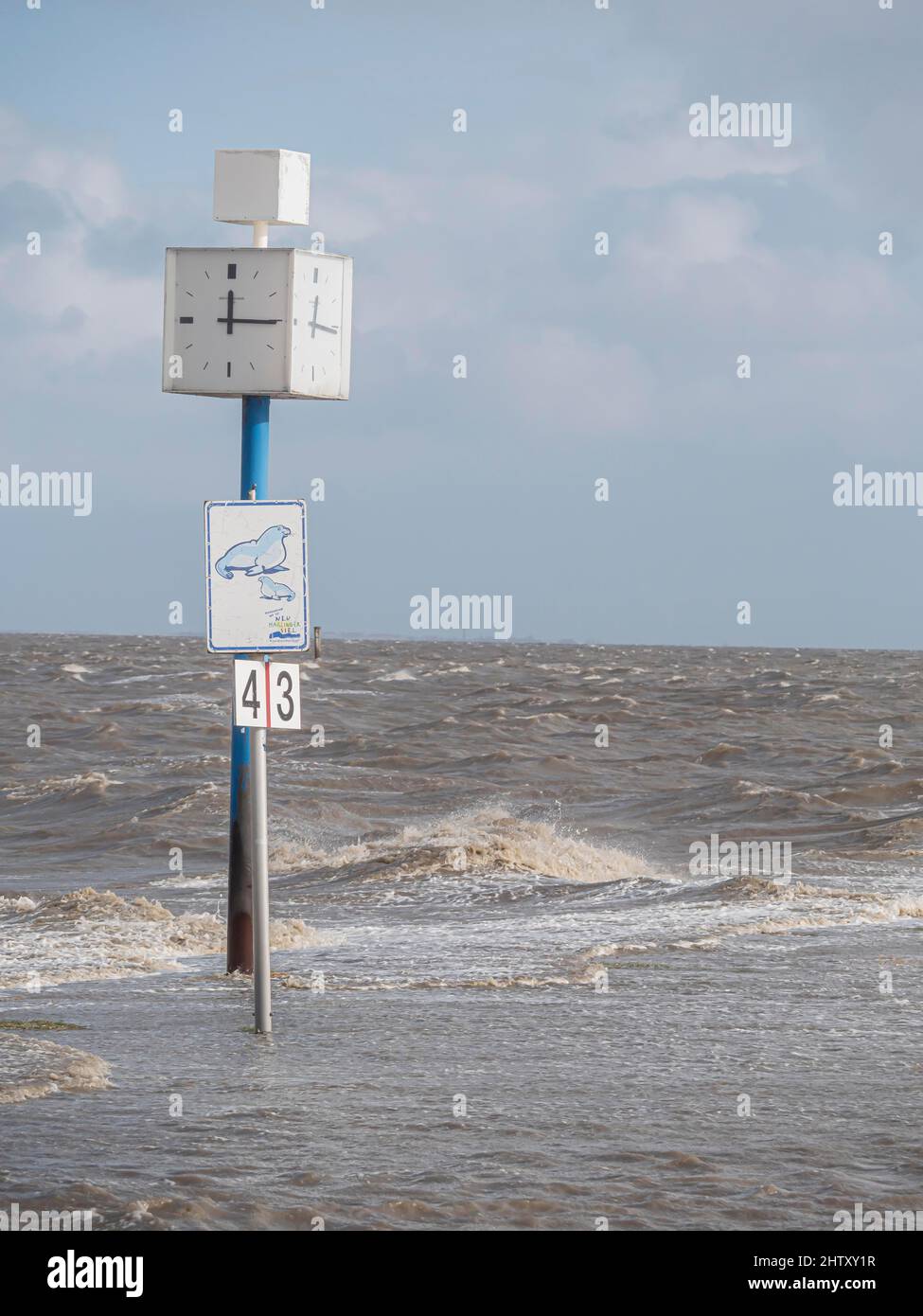 North Sea at storm surge, promenade flooded, clock and sign in the sea ...